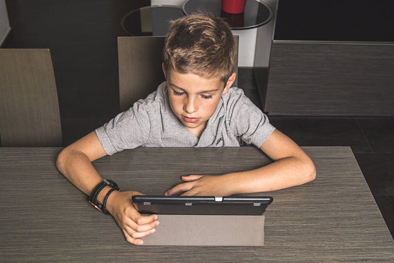 Child Watching a Tablet at Home Stock Image - Image of game, technology ...