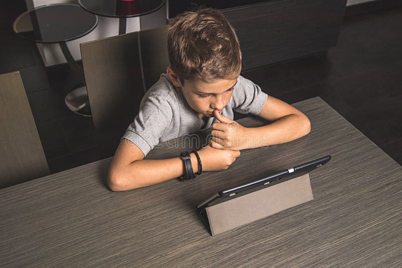 Child Watching a Tablet at Home Stock Image - Image of smiling, relaxed ...