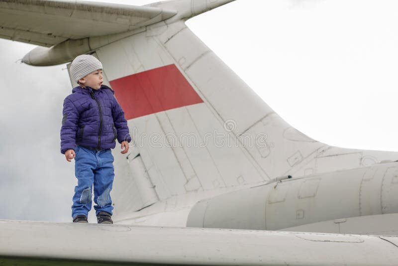 Child on the Wing of a Jet Plane Stock Image - Image of airplane ...