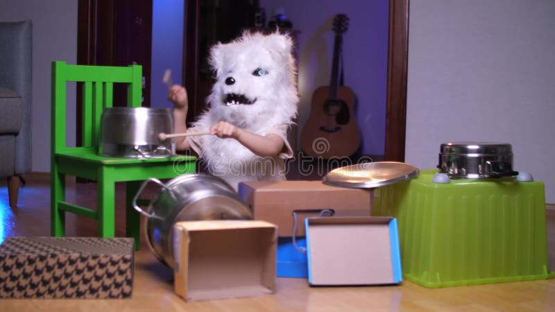A Child in a Wolf Mask for Halloween Plays on a Drum Set, Rock Band at ...