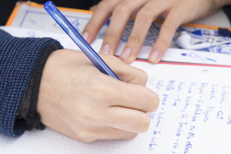 Child writing in the book stock photo. Image of homework - 94704678