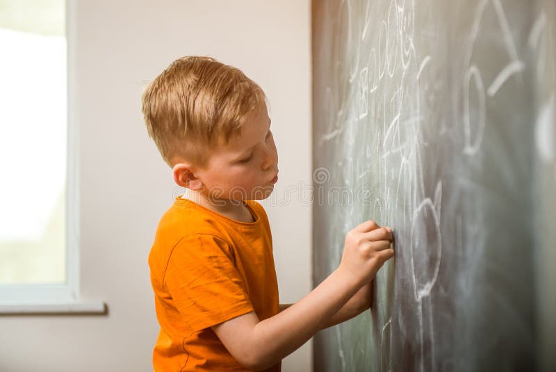 Child Writing on Chalkboard. Back To School. Kid with Chalk in Hand in ...