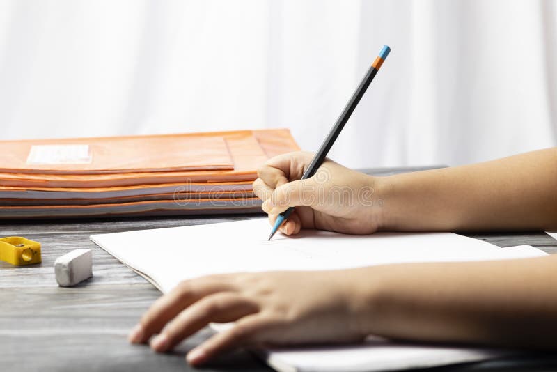 Child writing with pencil stock image. Image of childhood - 220172179