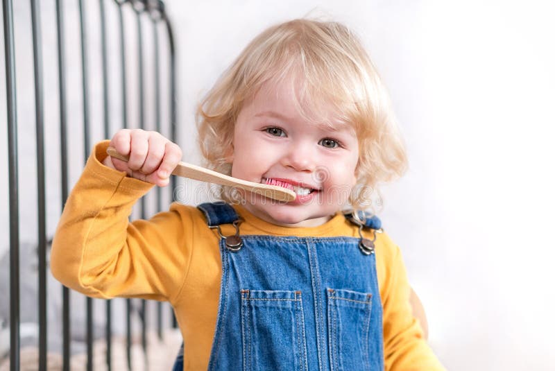 Child in a Yellow T-shirt with Clean Teeth Brushing on a Light ...