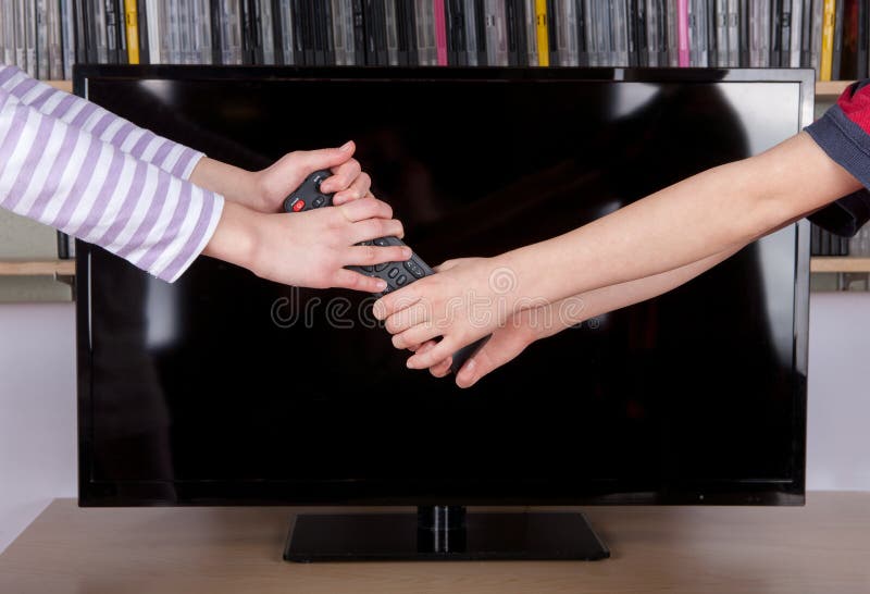 Hands Fighting for the Remote Control in Front of the TV Screen Stock ...