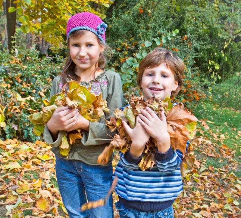 Children in Autumn Forest. Play with Fallen Down Leaf Stock Photo ...