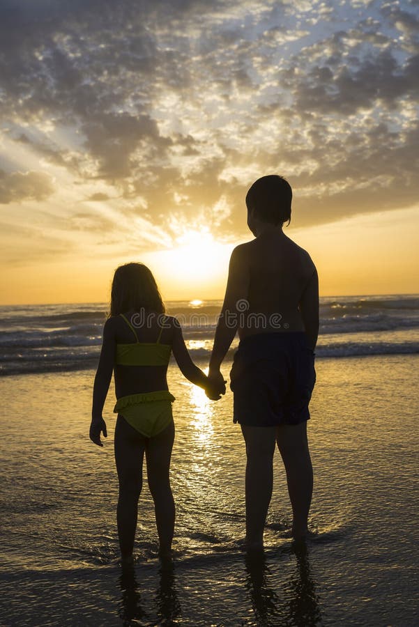 Children Bathing on the Beach at Dusk Stock Photo - Image of nature ...