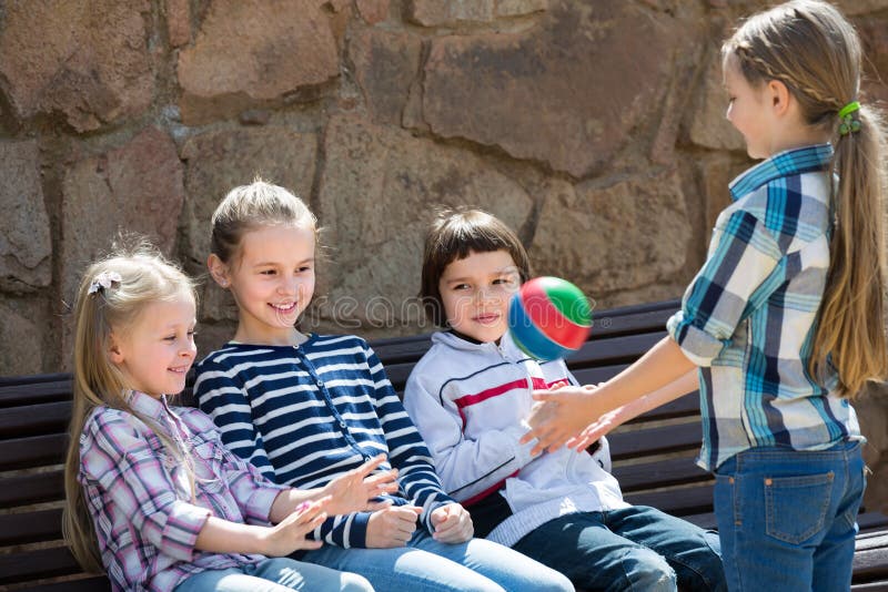 Children on the Bench Playing with Ball Stock Image - Image of group ...