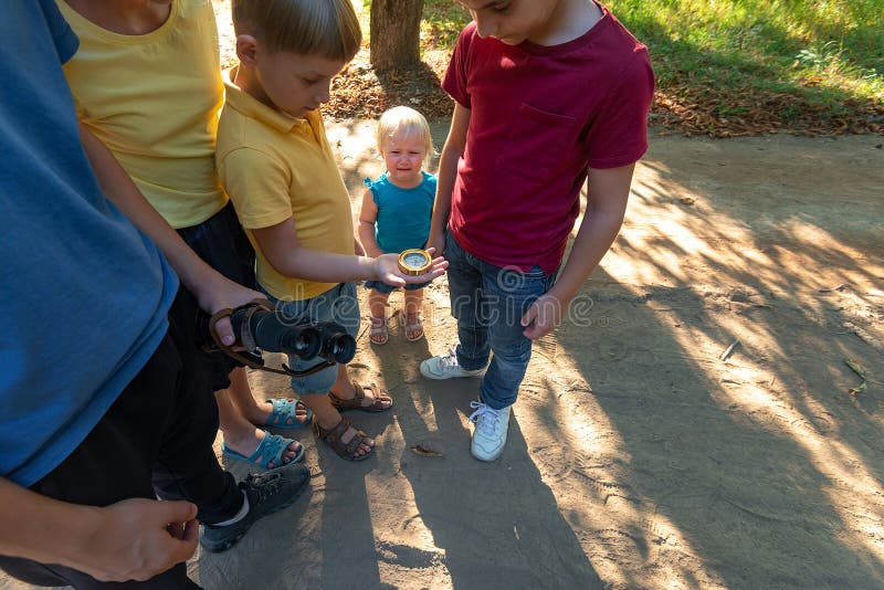 Children with Binoculars and a Compass are Discussing the Way Forward ...
