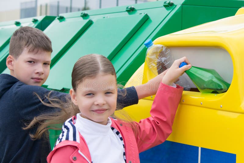 Children, a Boy and a Girl, Throw Empty Plastic Bottles into a Garbage ...