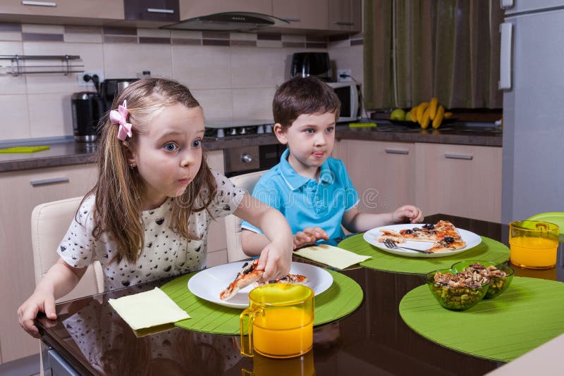 Children Captivated by a TV Show while Eating Stock Image - Image of ...