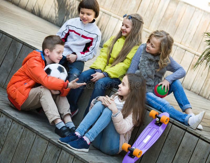 Children chatting outdoors stock image. Image of outside - 77546749