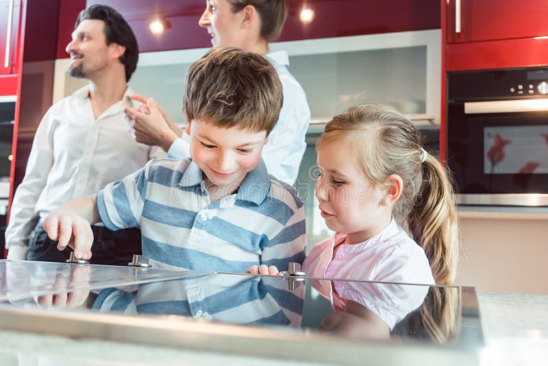Children Checking Out the New Kitchen Their Parents are about To Buy ...