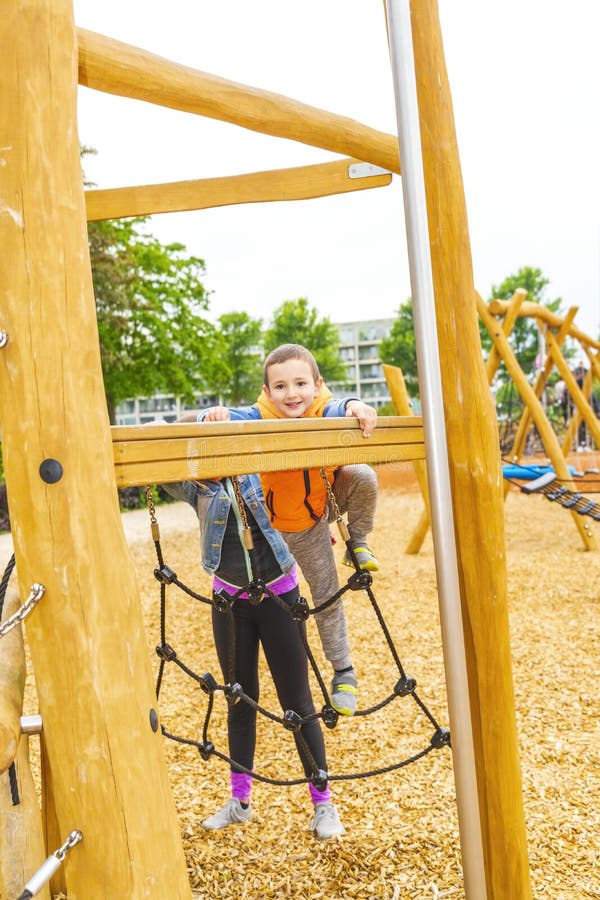 The Children Climbing and Sliding on Slide in the Playground. Happy ...