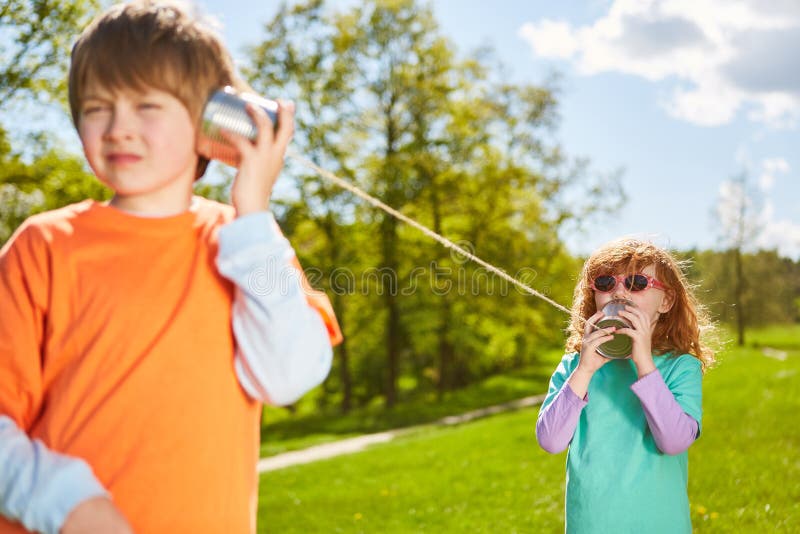 Children Communicate while Sitting on a Bench Stock Photo - Image of ...