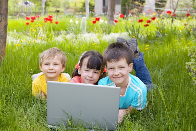 Children with computer stock image. Image of young, meadow - 786349