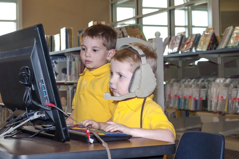 Young Boys Using a Computer Stock Photo - Image of learning, library ...