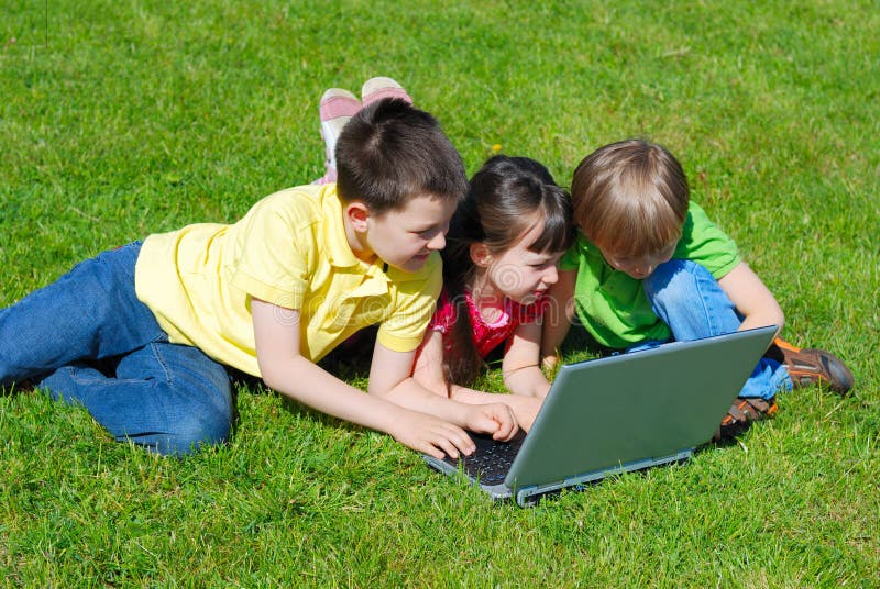 Children with Computer Outdoor Stock Photo - Image of girl, grass: 2486692