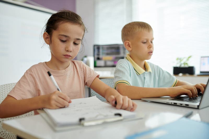 Children Concentrating on Homework in Modern Classroom Setting Stock ...