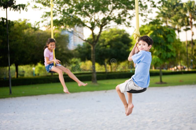 Children Dangling on the Suspension Rope in Playgr Stock Photo - Image ...