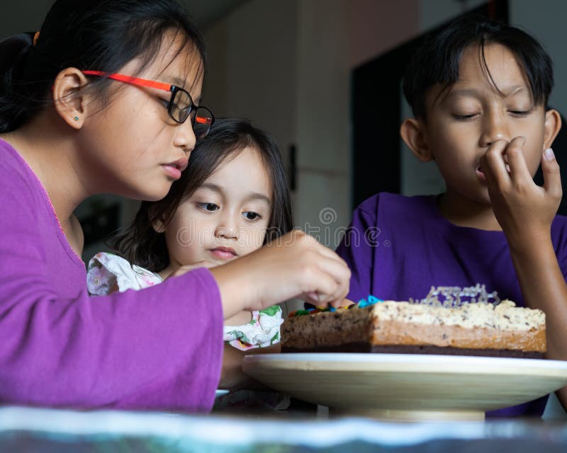 Children Decorating Their Birthday Cake with Chocolate and Sweets Stock ...