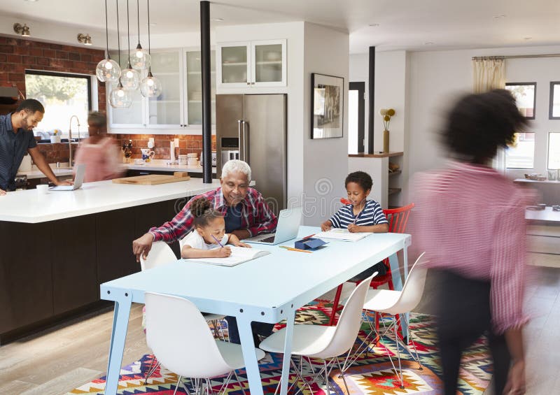 Children Doing Homework in Busy Multi Generation Family Home Stock ...