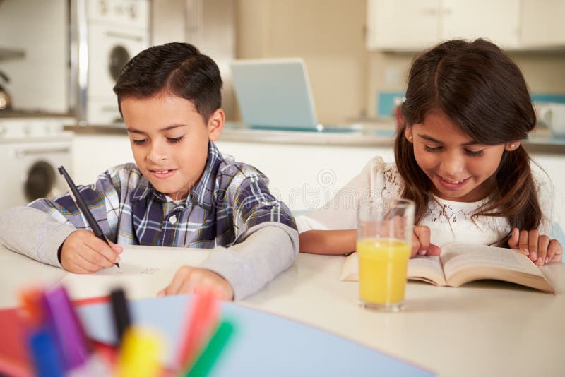 Children Doing Homework Together at Table Stock Photo - Image of ...