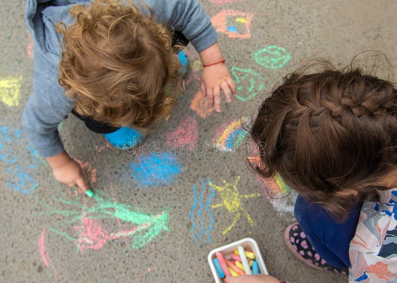Children Draw Equations on the Pavement with Chalk. Selective Focus ...