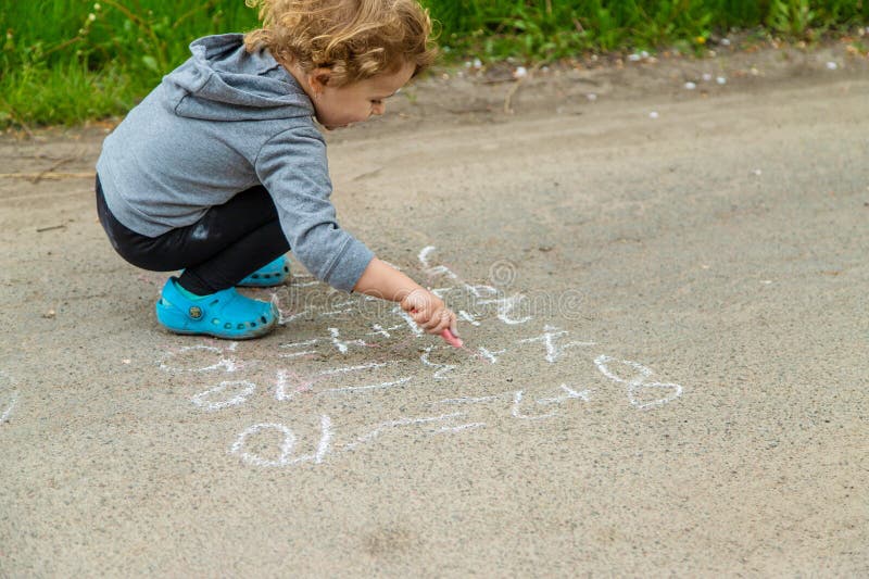 Children Draw Equations on the Pavement with Chalk. Selective Focus ...
