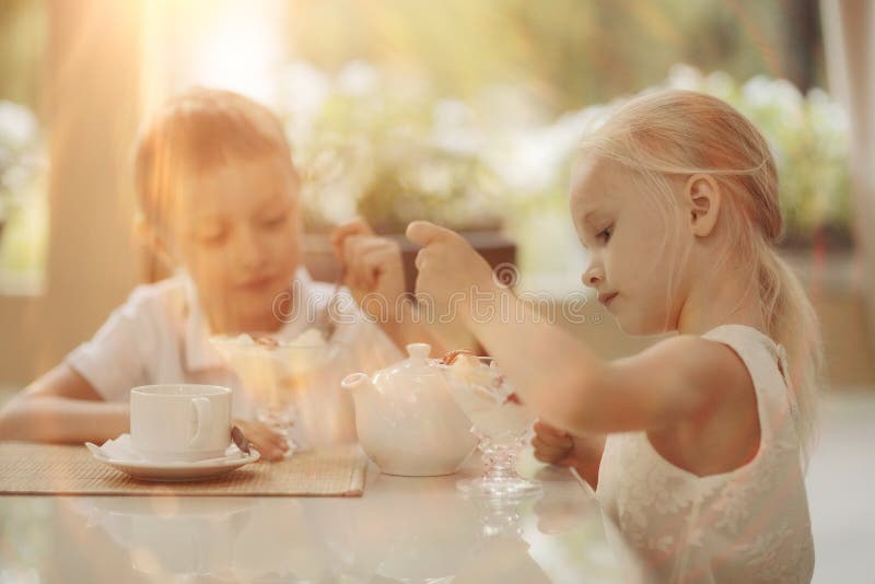Children drink tea in cafe stock photo. Image of group - 63871798