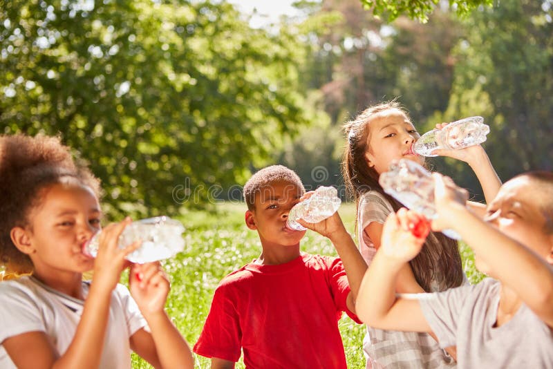 Children Drink Water with Straw on Meadow Stock Photo - Image of ...