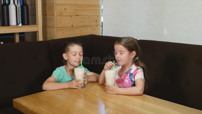 Children Drinking Milk Shake in a Cafe Stock Video - Video of cold ...