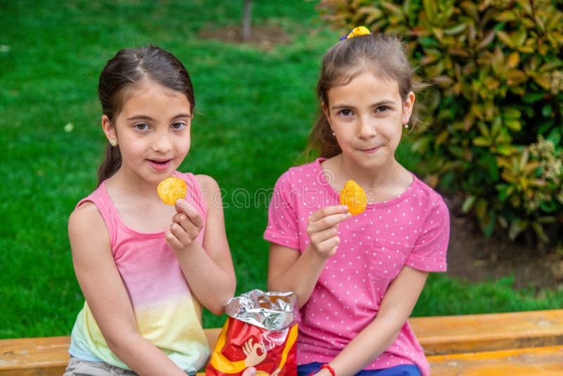 Children Eat Chips in a Friend S Park. Selective Focus. Stock Image ...