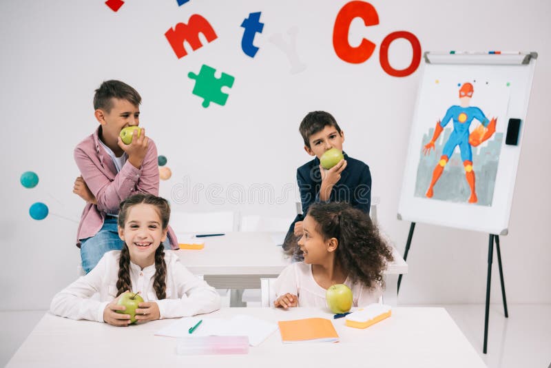 Children Eating Apples while Sitting in Classroom during Break Stock ...