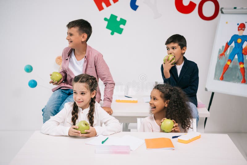 Children Eating Apples while Sitting in Classroom during Break Stock ...