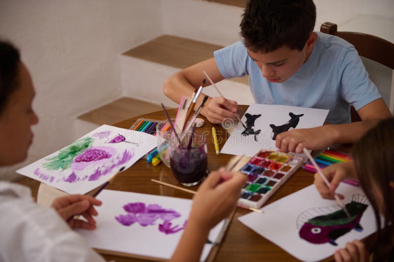 Children Engaged in Group Painting Activity Using Watercolors and ...