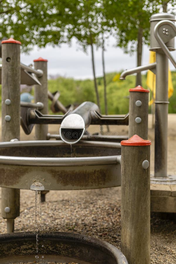Children Enjoy a Water Play Area Equipped with Various Interactive ...