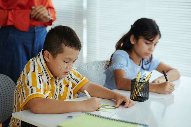 Children Focusing on Classroom Writing Activity Stock Photo - Image of ...