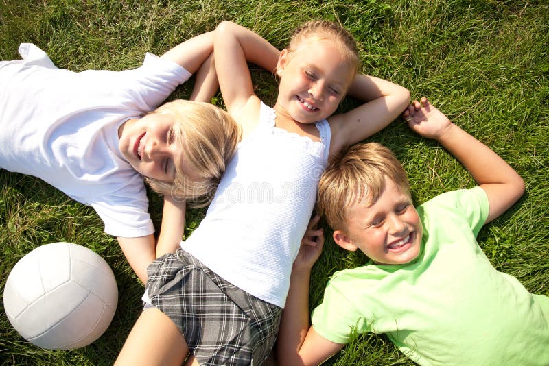 Children on grass stock image. Image of friendship, lying - 25310109