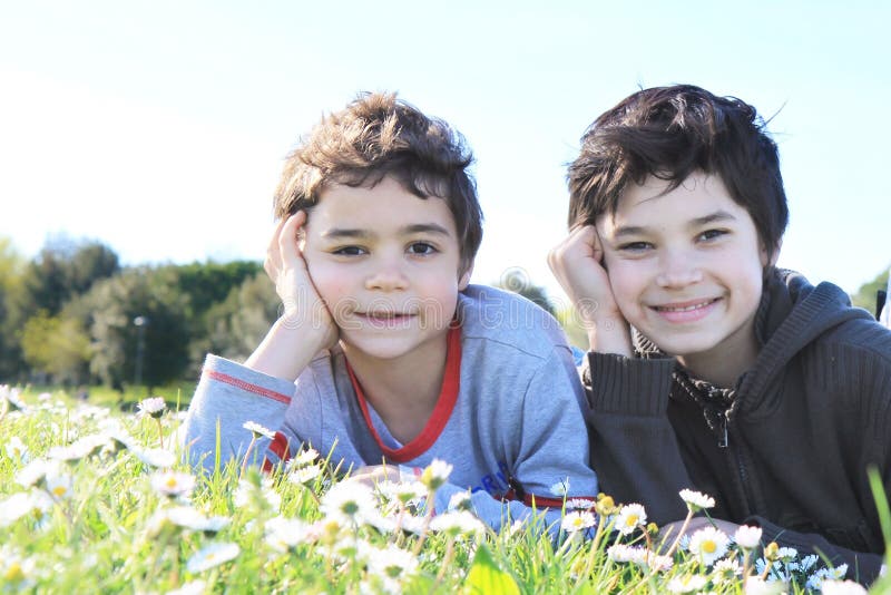 Children on green grass stock photo. Image of flower - 40261052