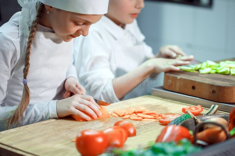 Children Grind Vegetables in the Kitchen of a Restaurant. Stock Photo ...