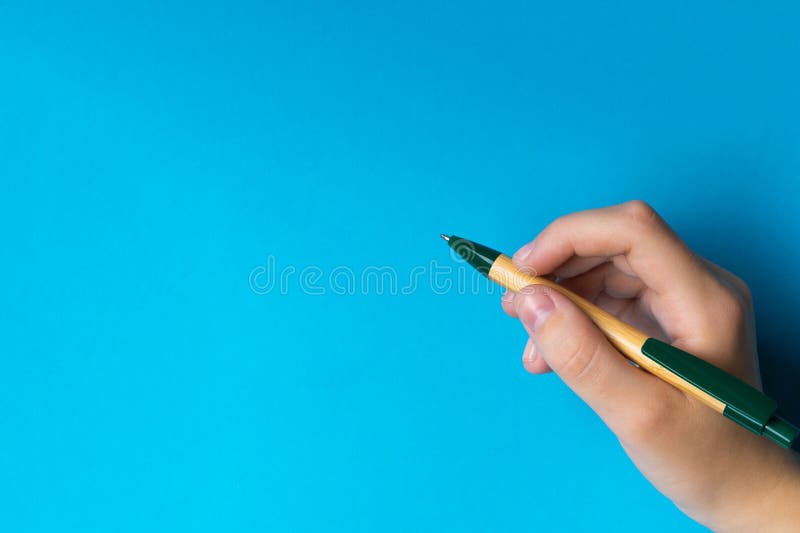 Children Hand with Pen Write on an Blue White Background. Writing Hand ...