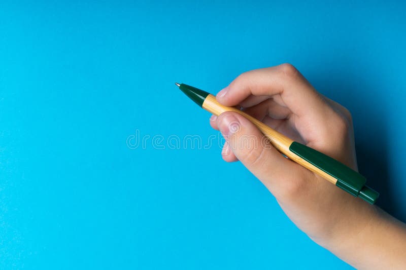 Children Hand with Pen Write on an Blue White Background. Writing Hand ...