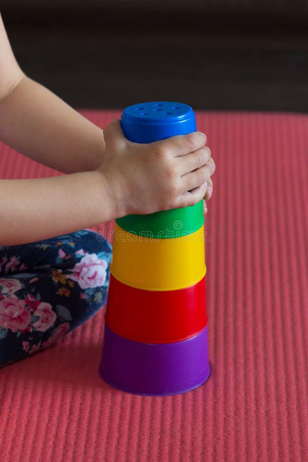 Children Hands Make Pyramid Using Colorful Stacking Cups Stock Image ...