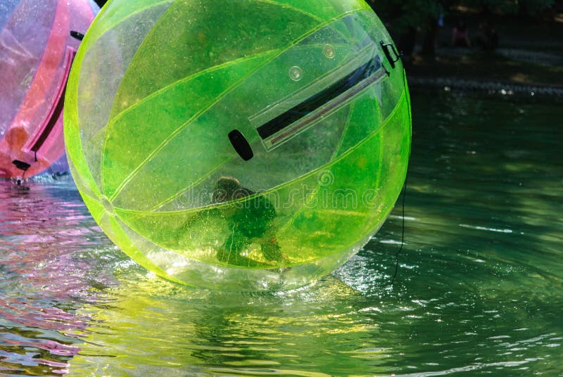 Children Have Fun Inside Plastic Balloons on the Water. Stock Image ...
