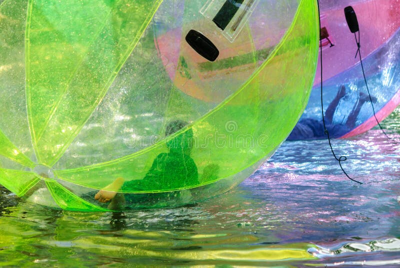Children Have Fun Inside Plastic Balloons on the Water. Stock Photo ...