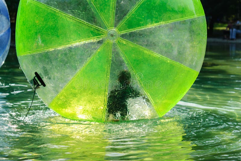 Children Have Fun Inside Plastic Balloons on the Water. Stock Image ...