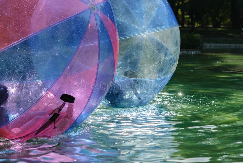 Children Have Fun Inside Plastic Balloons on the Water. Stock Image ...