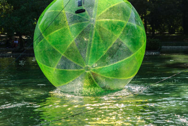 Children Have Fun Inside Plastic Balloons on the Water. Stock Photo ...