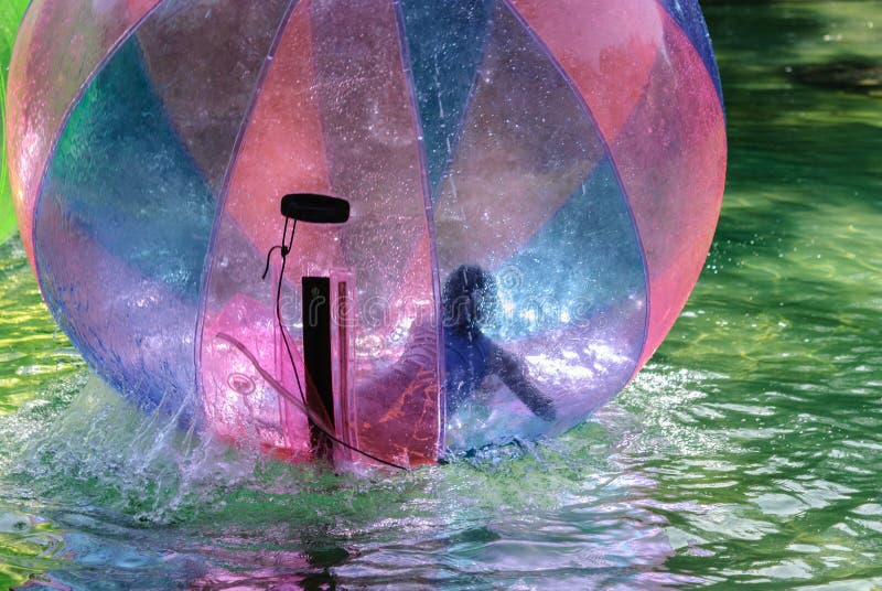 Children Have Fun Inside Plastic Balloons on the Water. Stock Photo ...